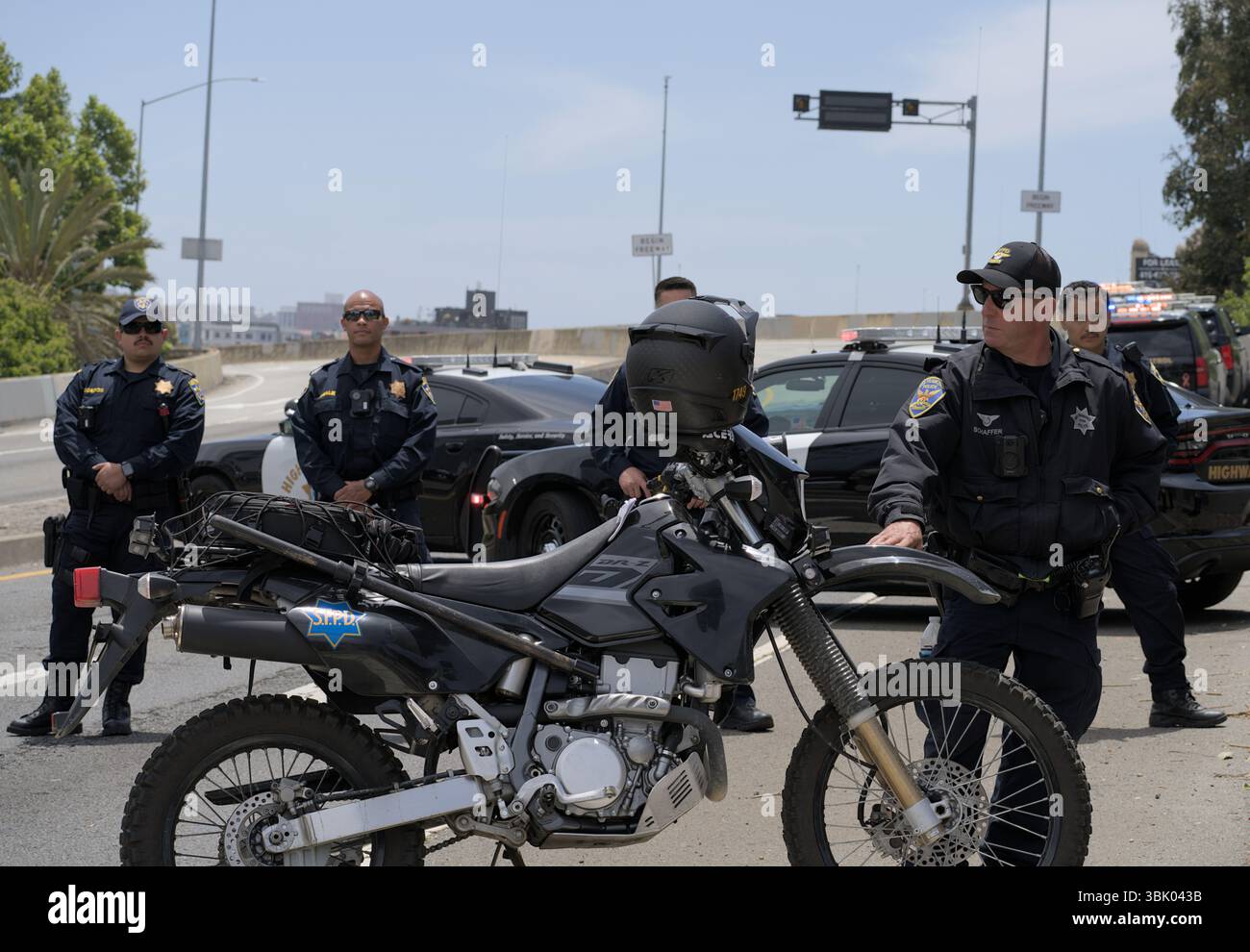 Police officers block freeway access during the No Kings protest in San ...