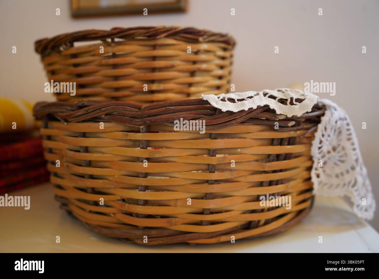 Cretan traditional baskets with a lace cloth detail, placed indoors on ...
