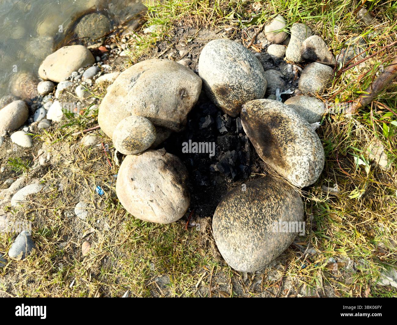 Extinguished Campfire Circle with Burnt Stones by the Riverside Stock ...