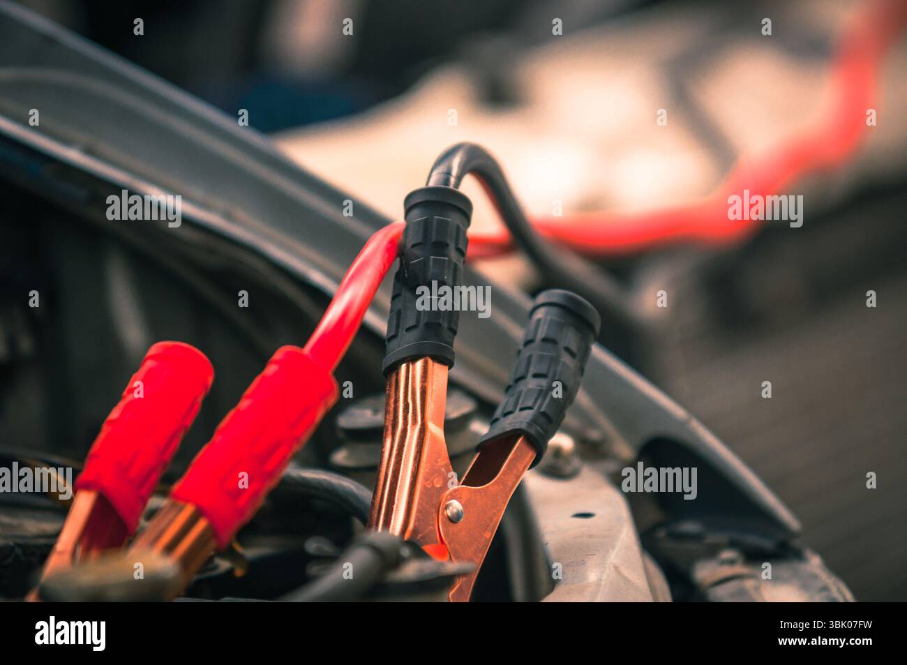 Charging car with electricity trough cables Stock Photo - Alamy