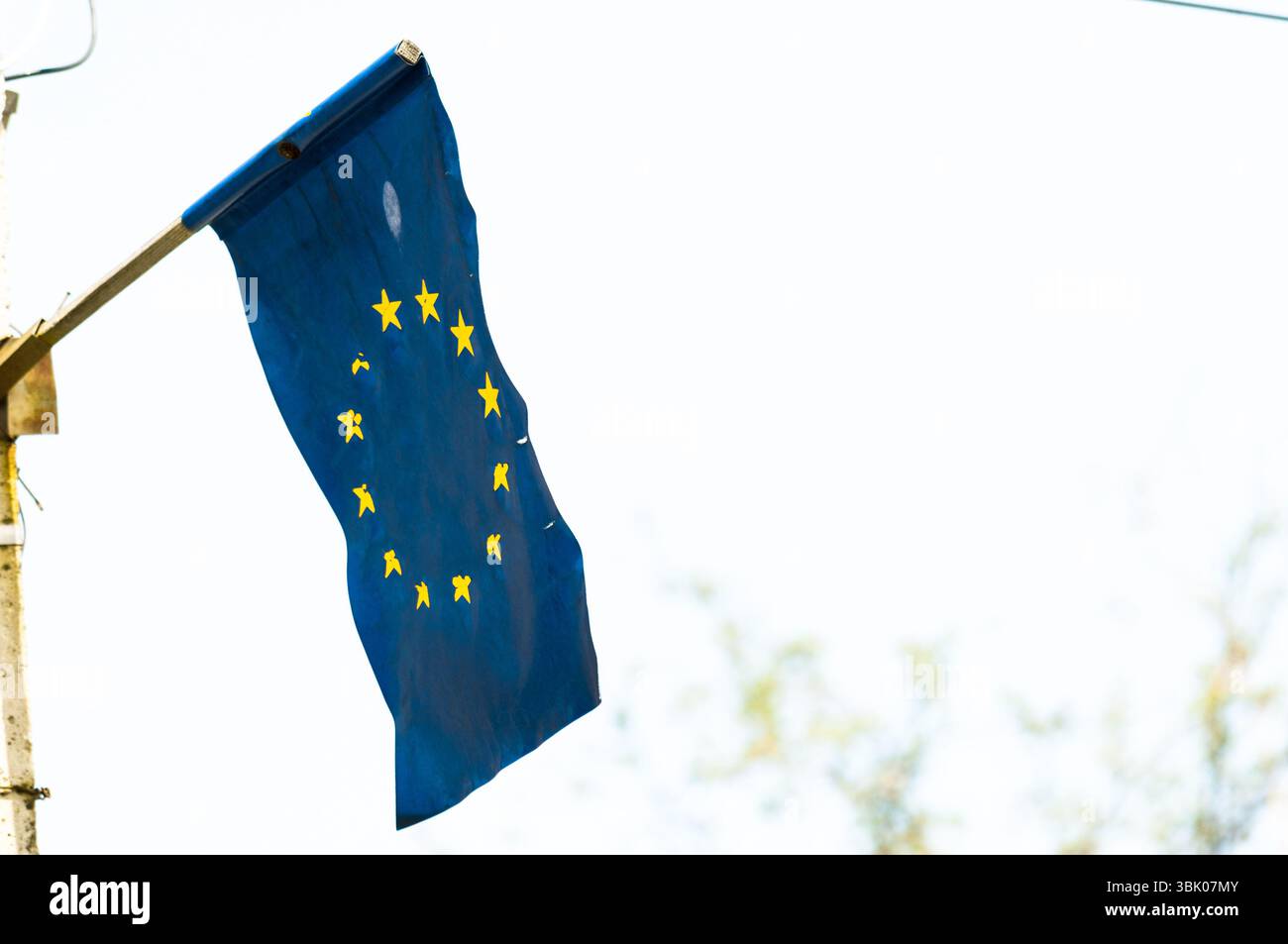 Damaged European Union flag against white background Stock Photo - Alamy