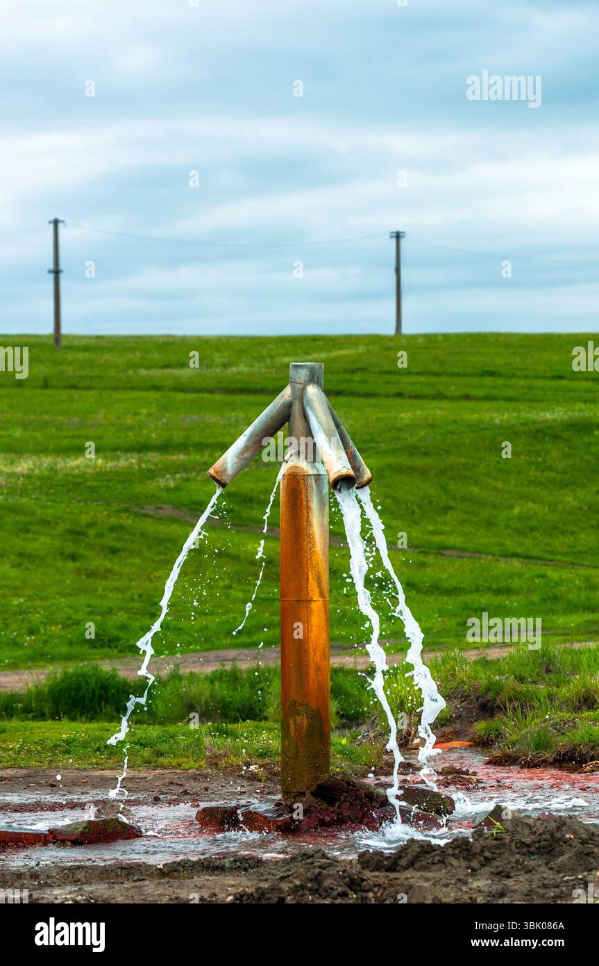 Water flowing from outdoor tap and getting wasted Stock Photo - Alamy