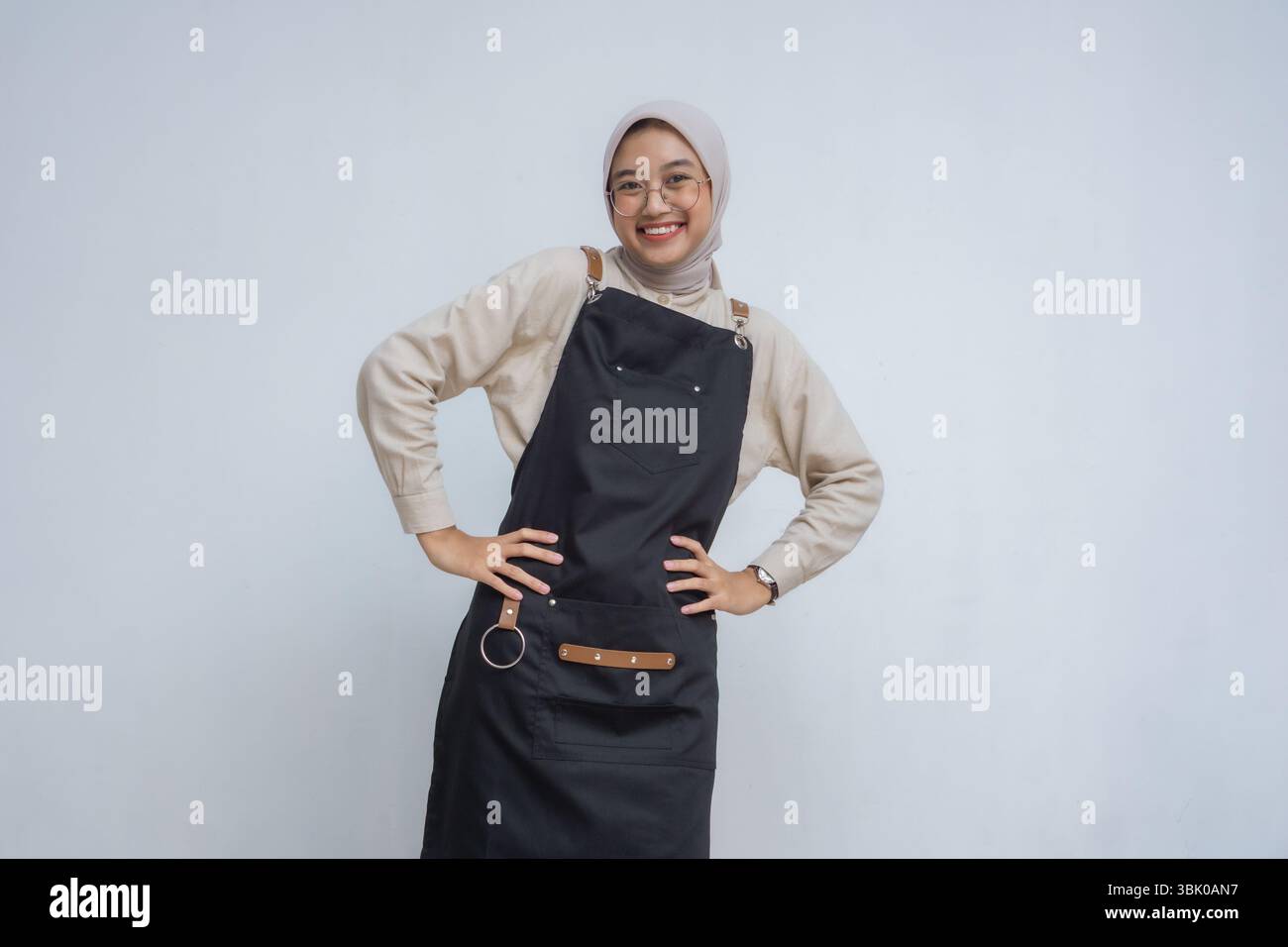 Asian young muslim wearing hijab and black apron Stock Photo - Alamy