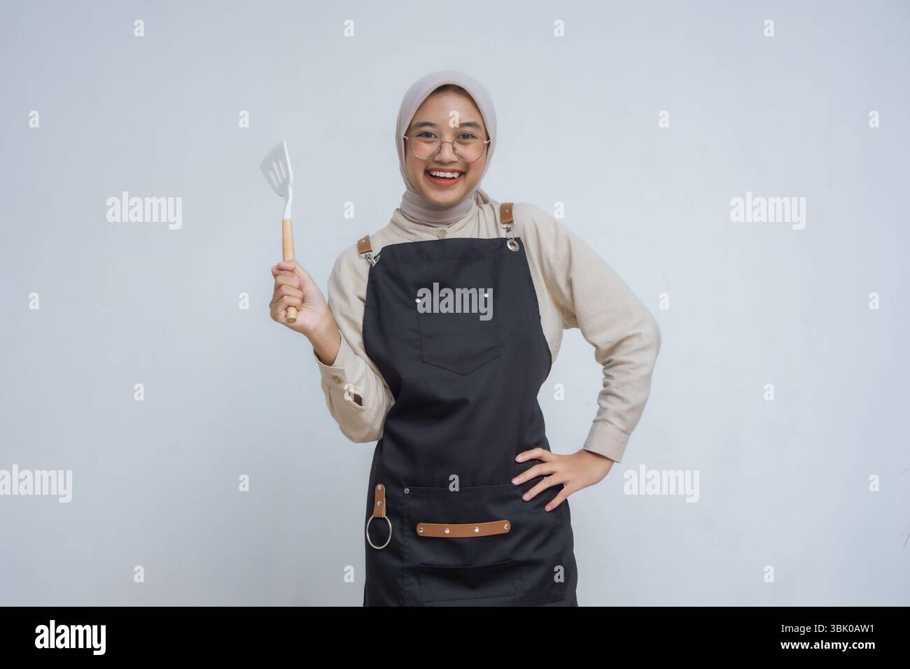 Asian young muslim wearing hijab and black apron Stock Photo - Alamy
