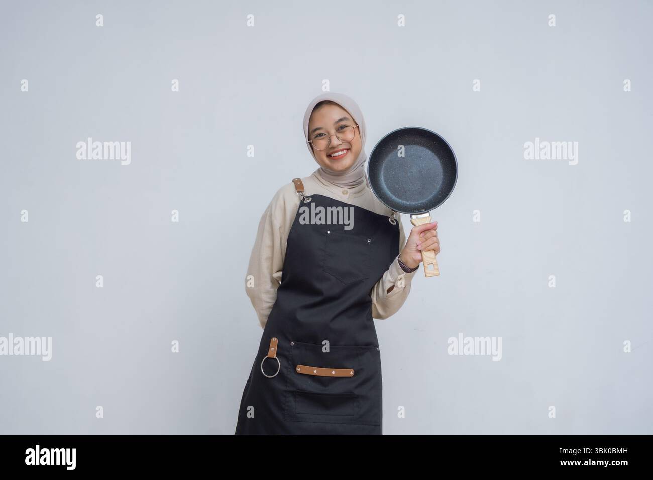 Asian young muslim wearing hijab and black apron Stock Photo - Alamy