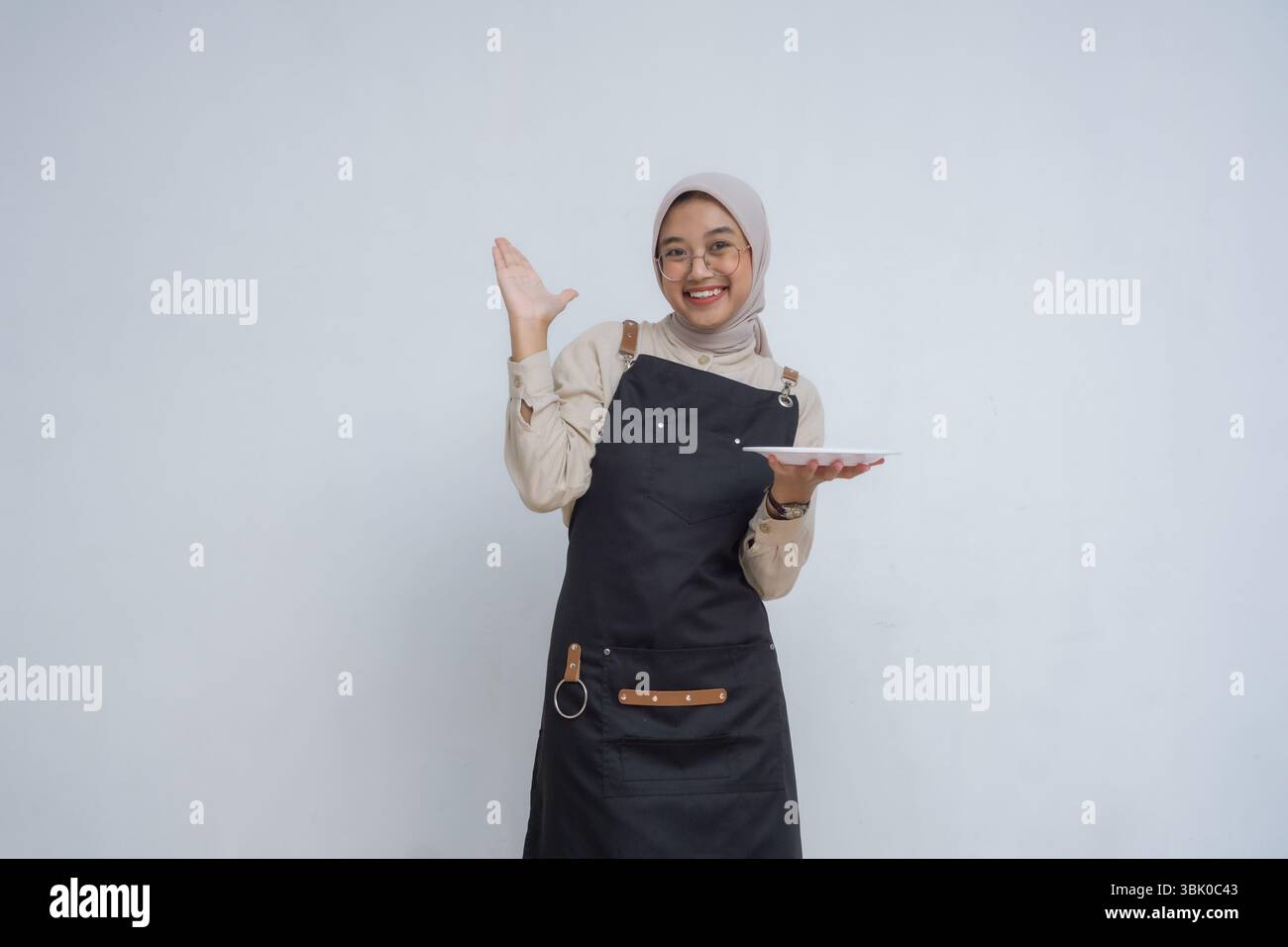 Asian young muslim wearing hijab and black apron Stock Photo - Alamy