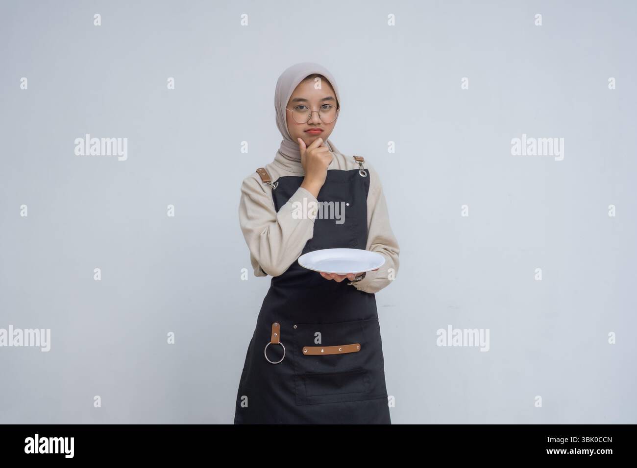 Asian young muslim wearing hijab and black apron Stock Photo - Alamy
