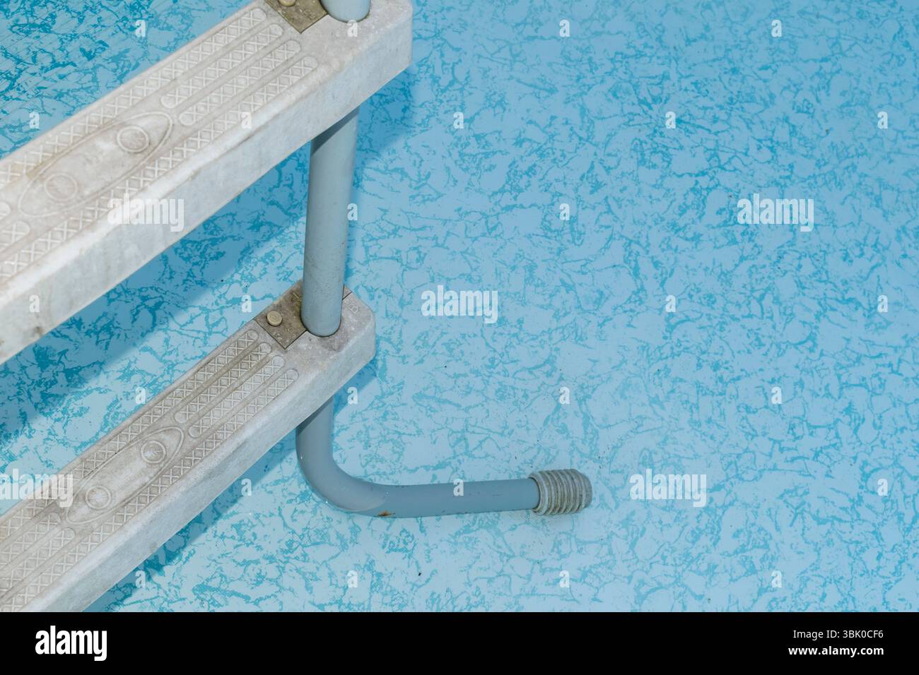 Pool ladder partially submerged in filling swimming pool Stock Photo ...
