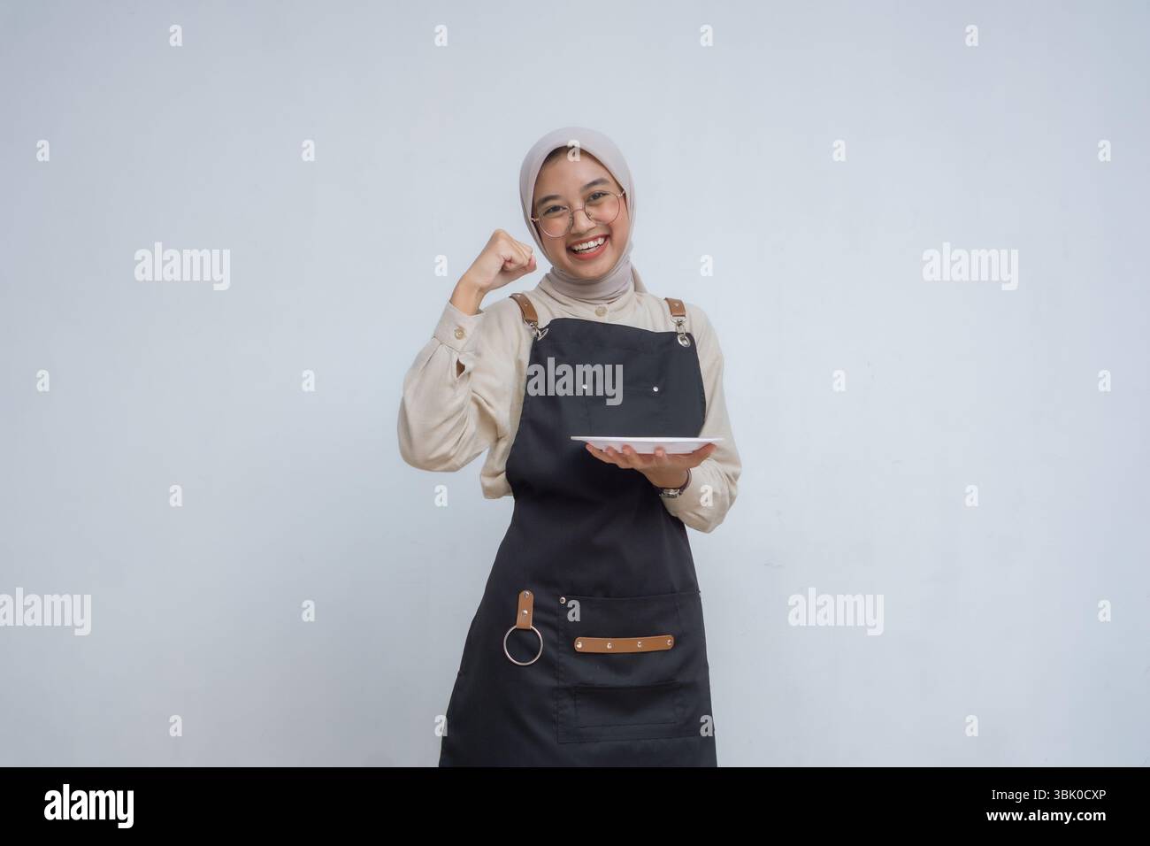 Asian young muslim wearing hijab and black apron Stock Photo - Alamy