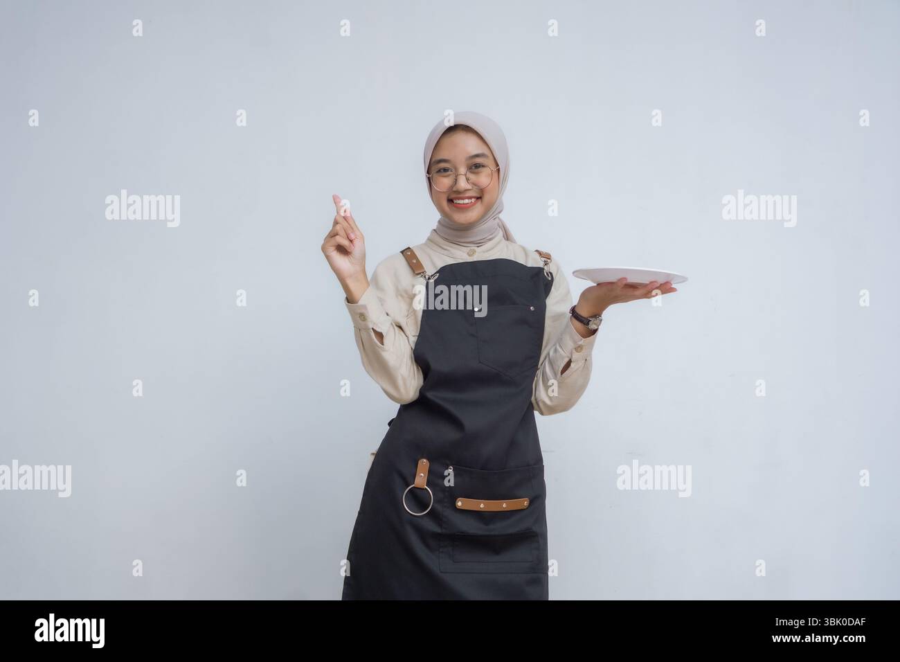 Asian young muslim wearing hijab and black apron Stock Photo - Alamy