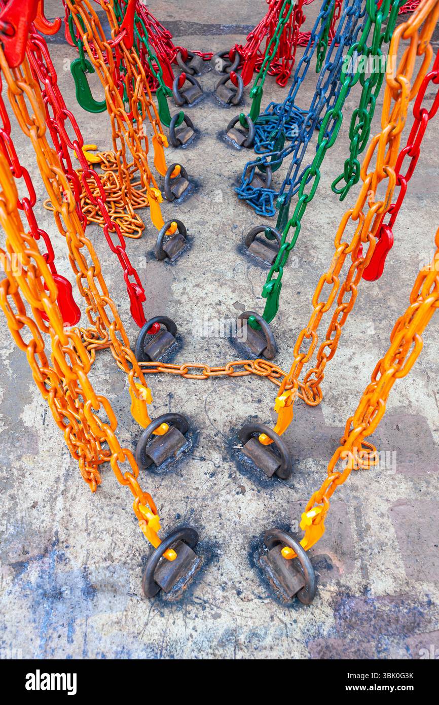 Multi-colored chains with hooks are attached to steel rings welded to ...