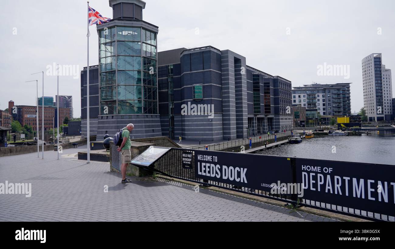 LEEDS, UK - JUNE 11, 2025 - Tourist reading a map at Leeds Dock, a ...