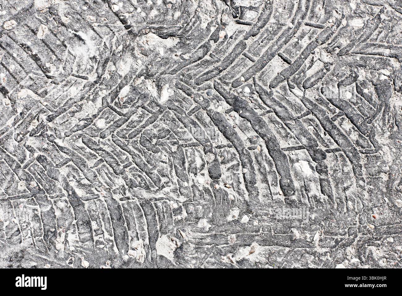 Melted asphalt with visible tire marks. Urban street texture background ...