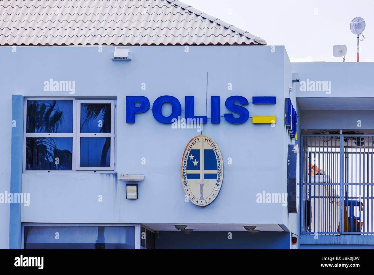 Close up view of entrance of Korps Politie Curacao building with blue ...