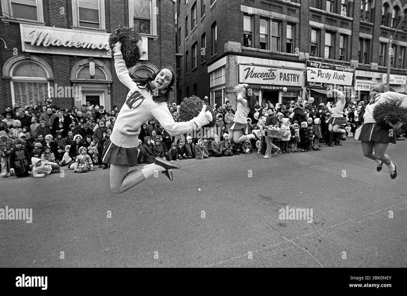 High school cheerleaders jump at a 1970 Fourth of July parade before ...