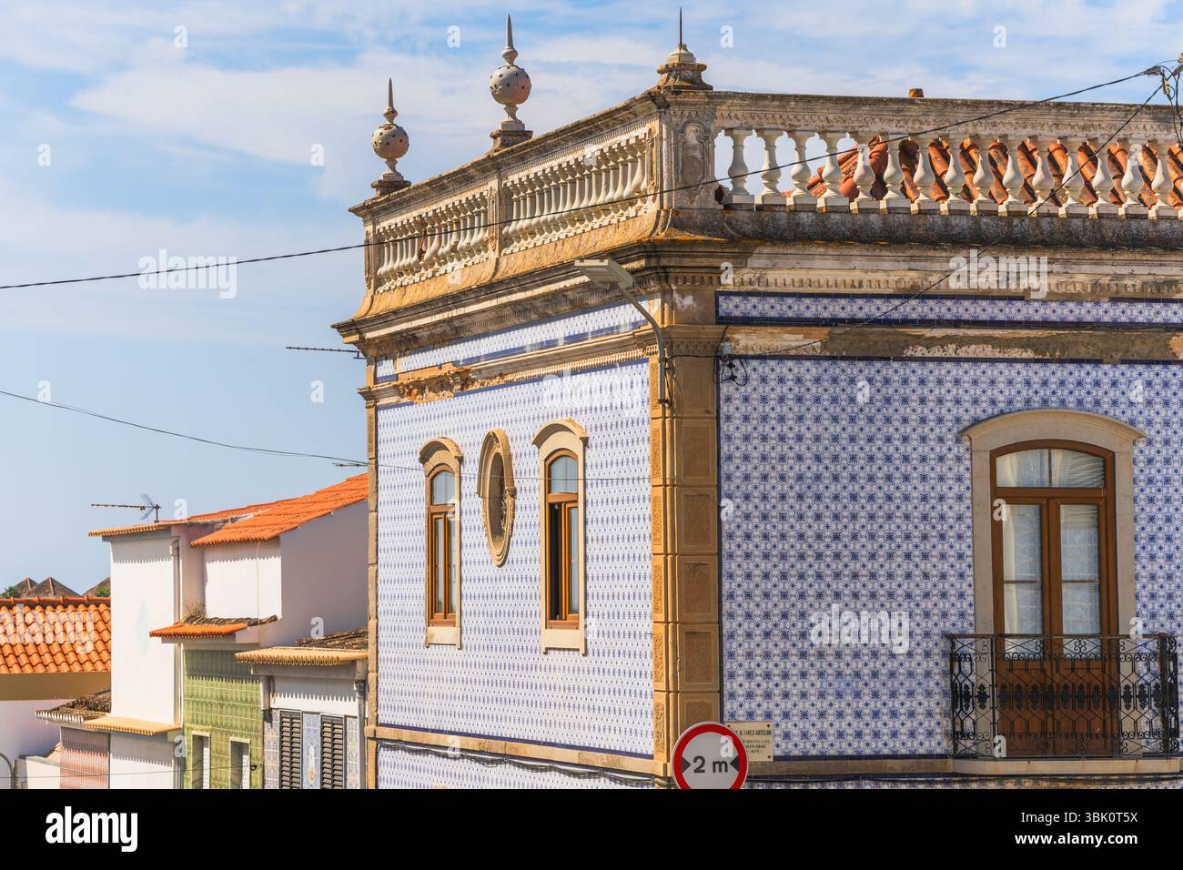 A historic corner building in Tavira features intricate blue and white ...
