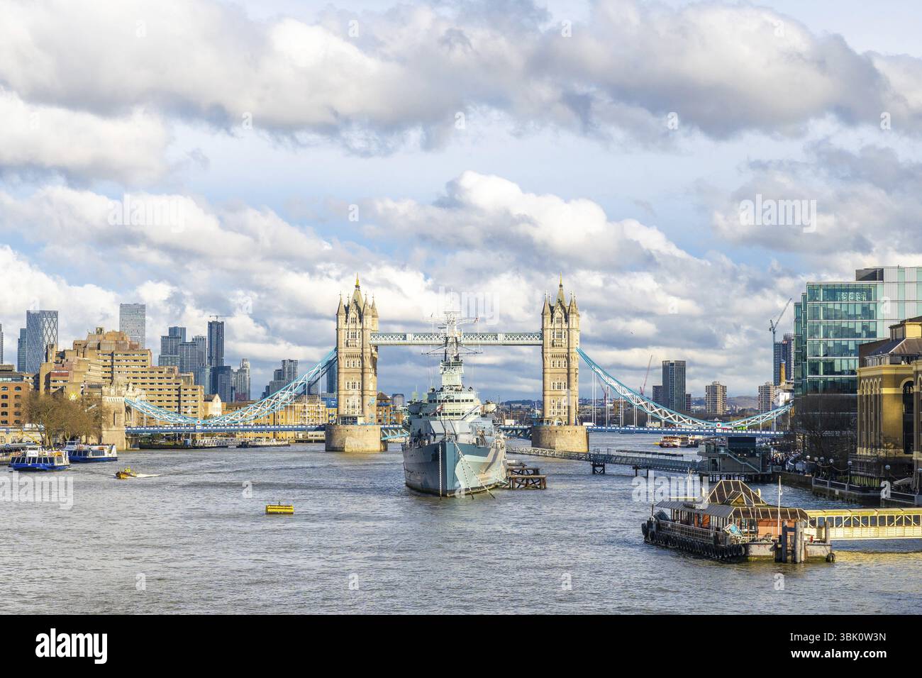 Hms belfast, a town class light cruiser, sailing on the river thames ...