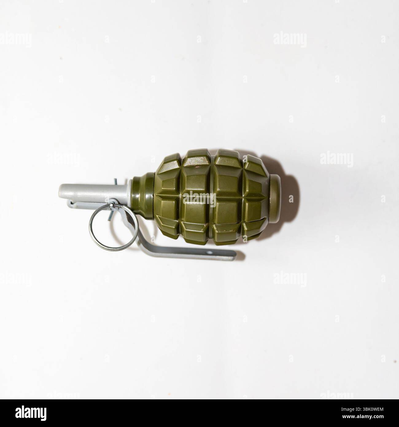 Close-up of plastic hand grenade model on white background. Military ...