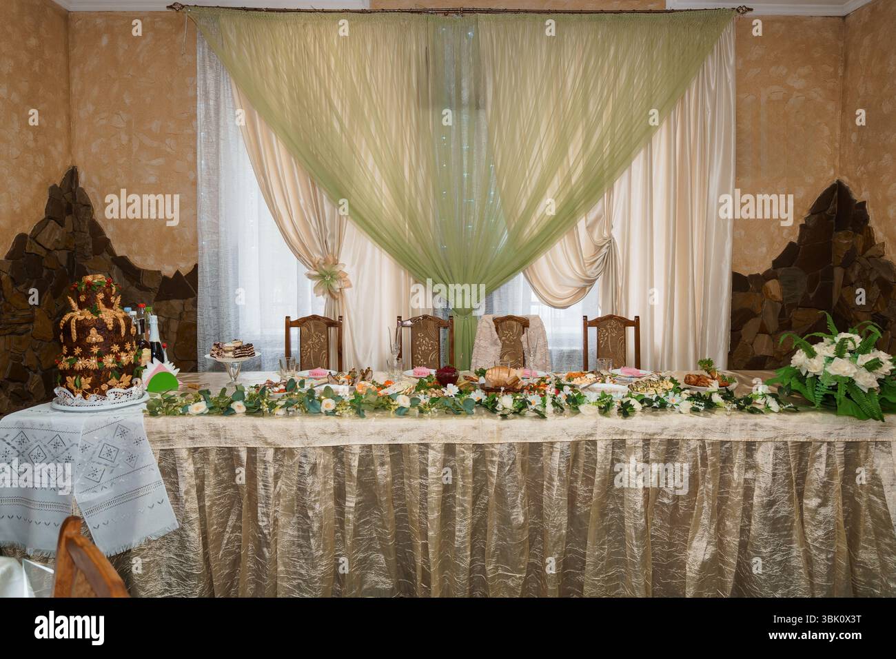An opulent wedding reception table spread showcases a two-tiered cake ...