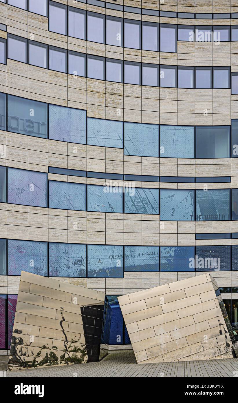 Building with undulating glass facade and artistic elements ...