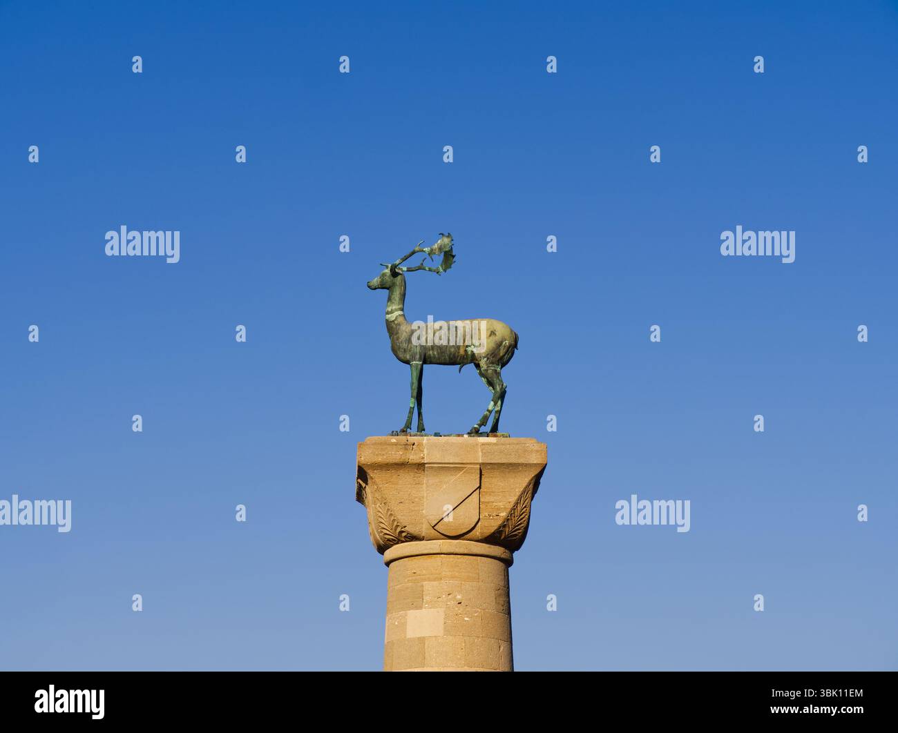 Famous bronze deer Stag statue in Rhodes port with antlers standing on ...