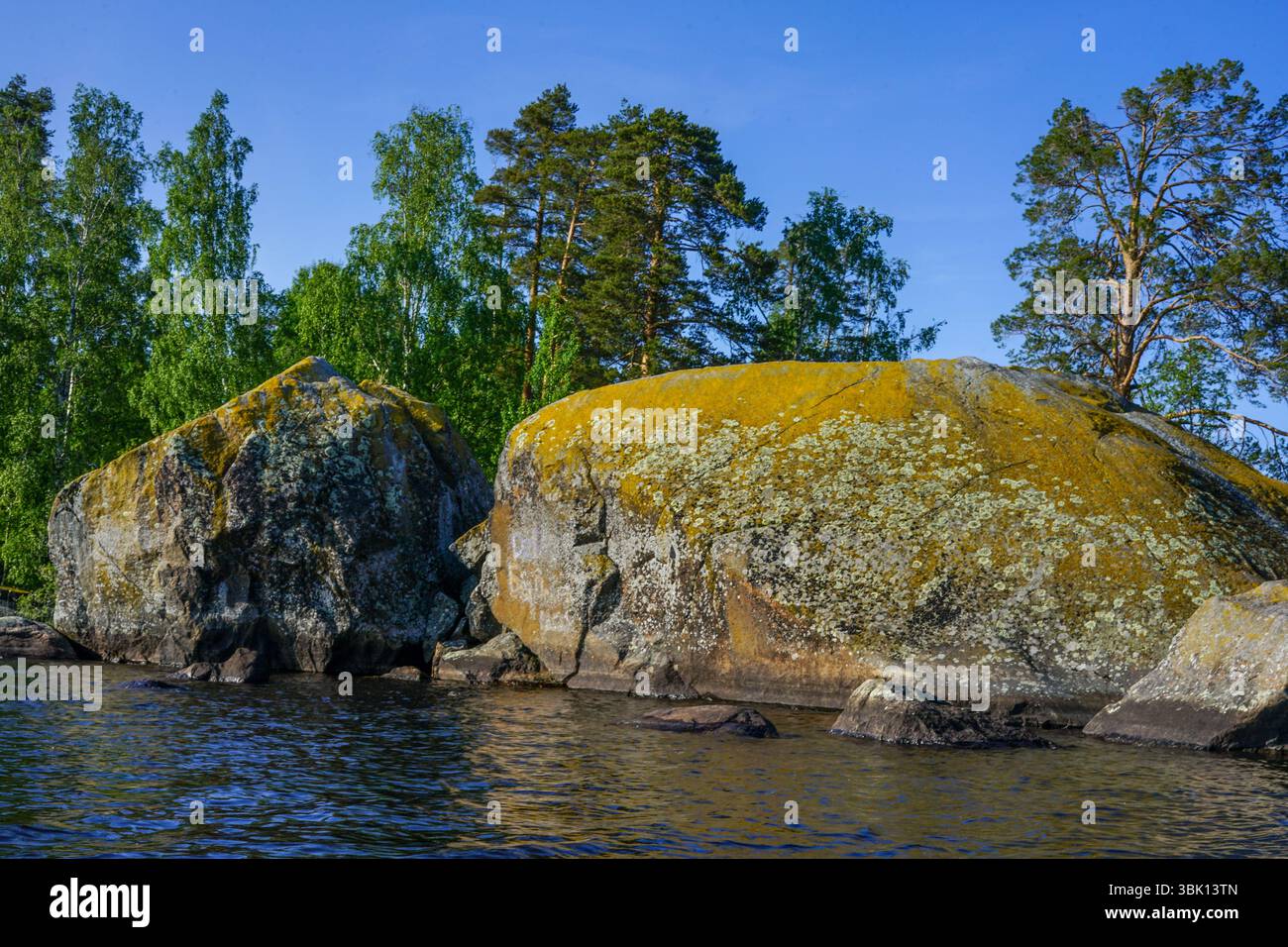 Rocks and Shoreline Scene with Sunlight and Water Reflections Stock ...