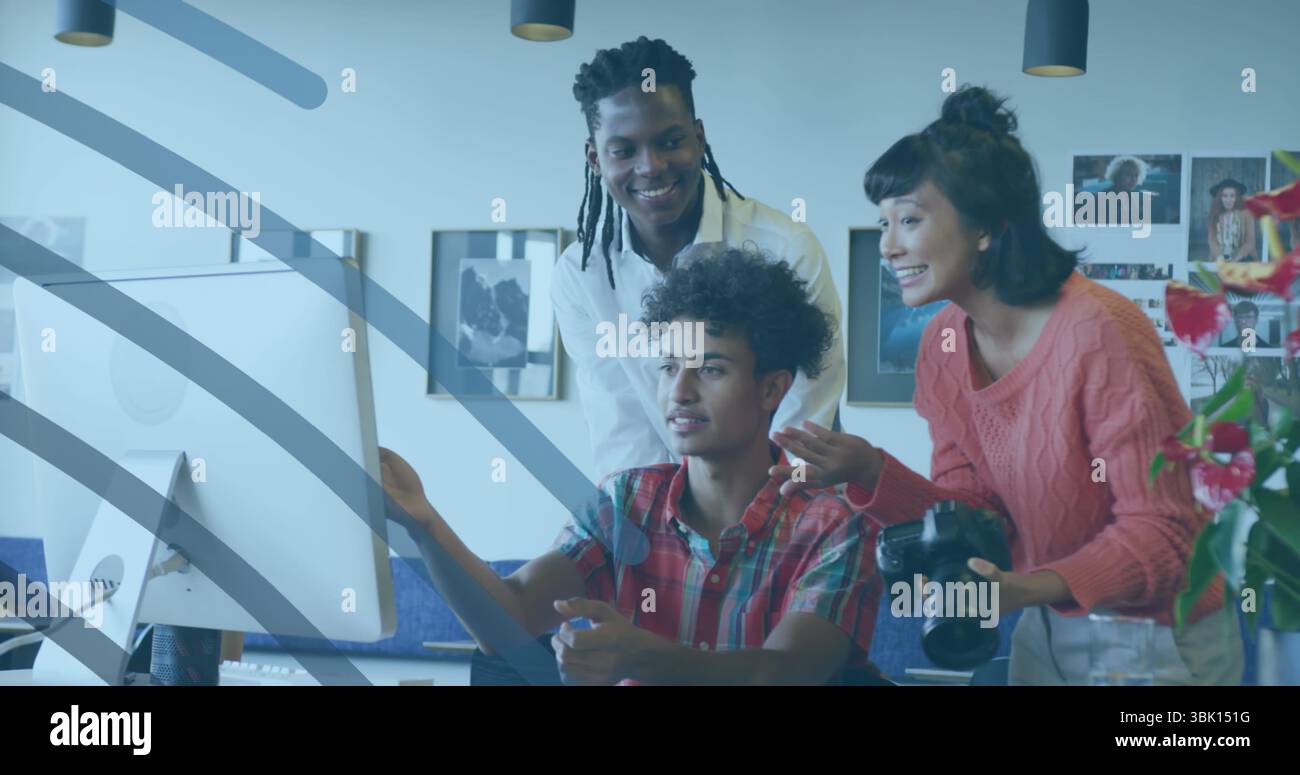 Pointing creative team examining project at office desk using graphic ...