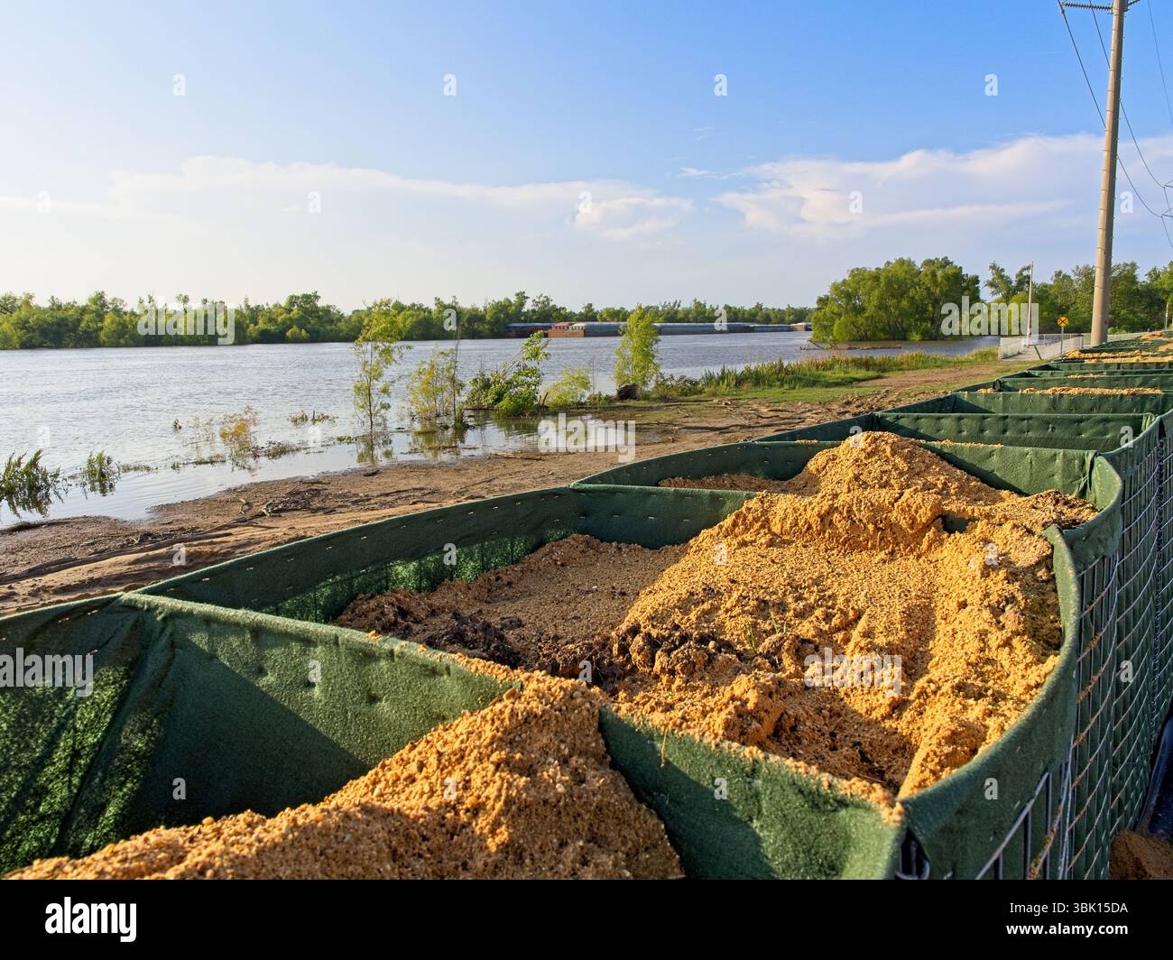 Earth filled flood control barriers line the banks of the Yazoo river ...