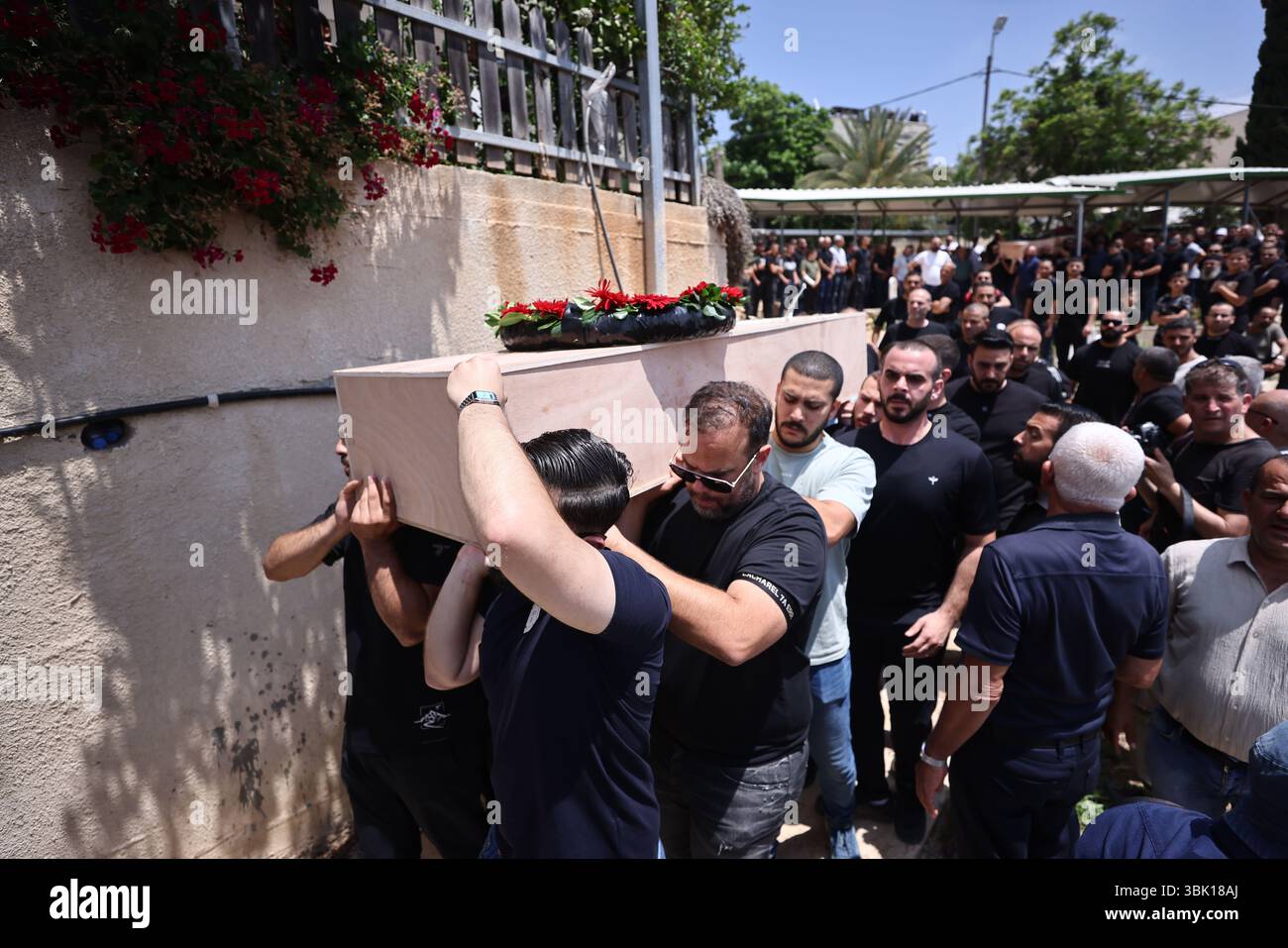 Tamra, Israel. 17th June, 2025. People carry a coffin during a funeral ...