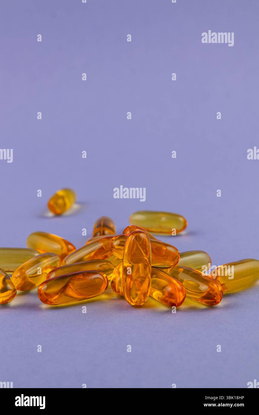Bright yellow capsules lie hi-res stock photography and images - Alamy