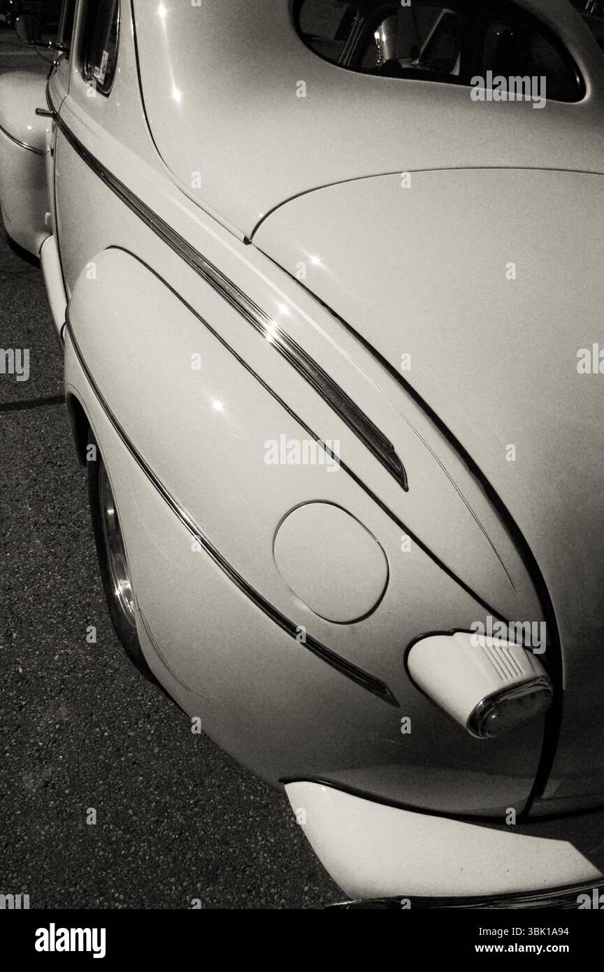 Rear window and fender of a Vintage Mercury Eight classic car in sepia ...