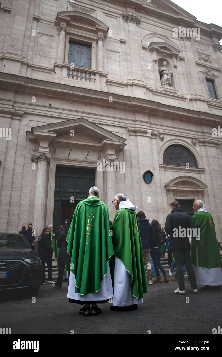 ROME, ITALY - JANUARY 15, 2025: Catholic priests in green liturgical vestments converse outside ...