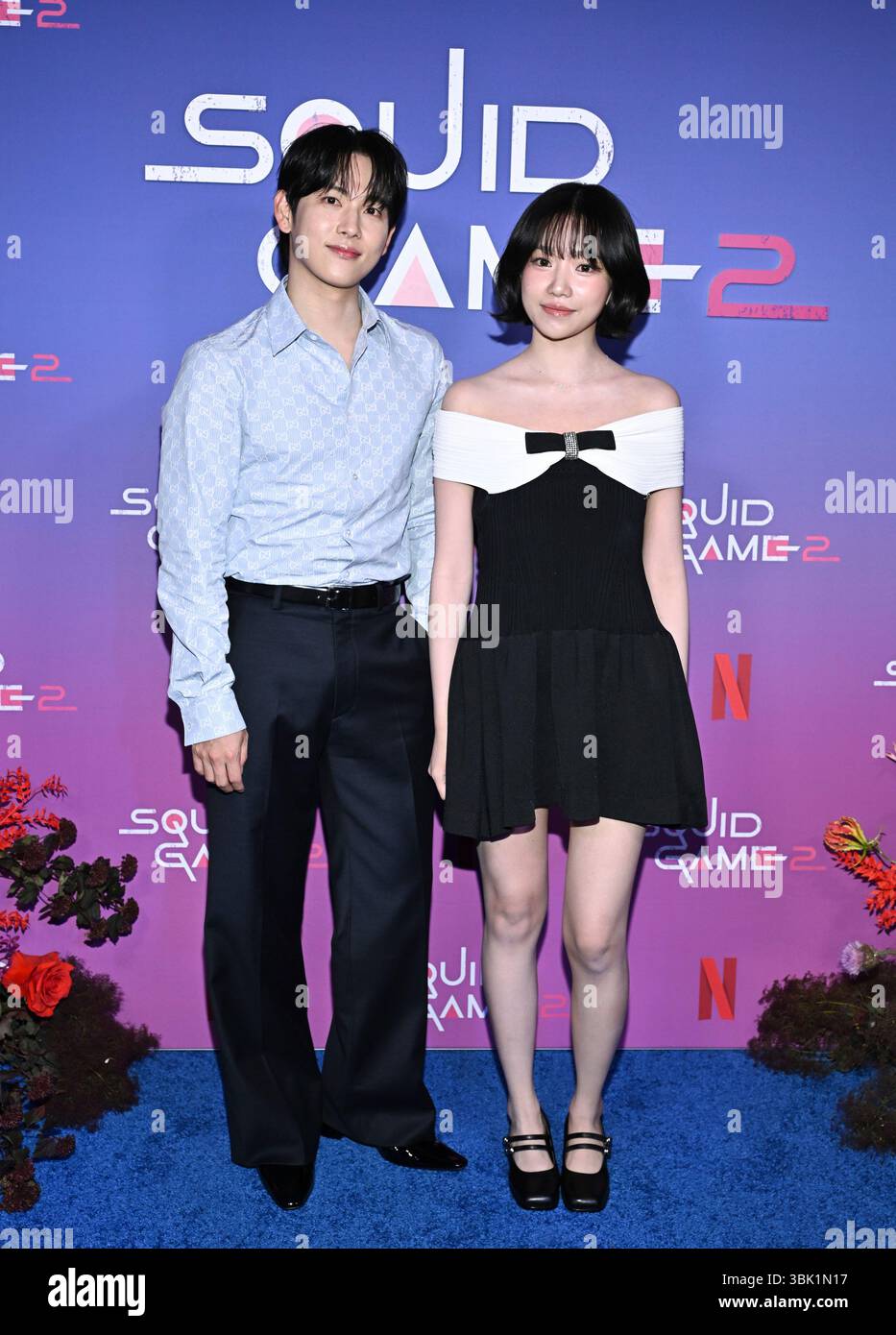 Yim Si-wan, left, and Jo Yu-ri pose together at a Netflix "Squid Game" cast photo call at the ...