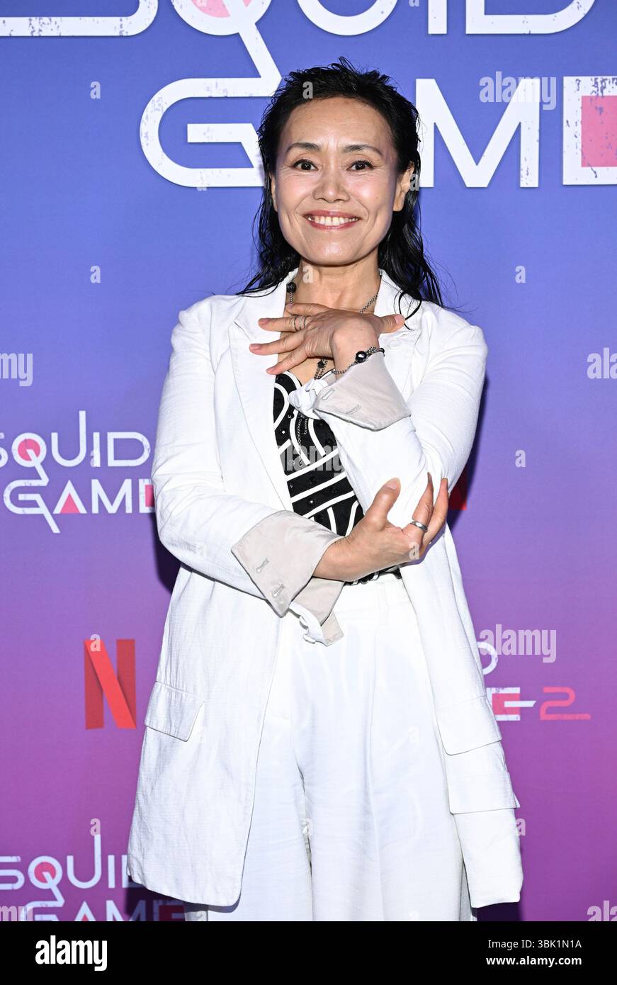 Kang Ae-sim poses at a Netflix "Squid Game" cast photo call at the ...