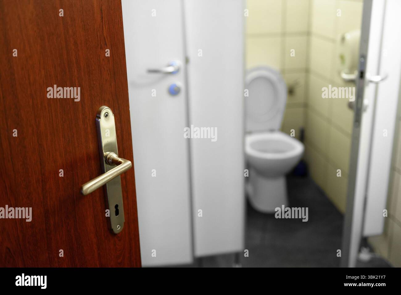 Opened door with toilet in the background Stock Photo - Alamy