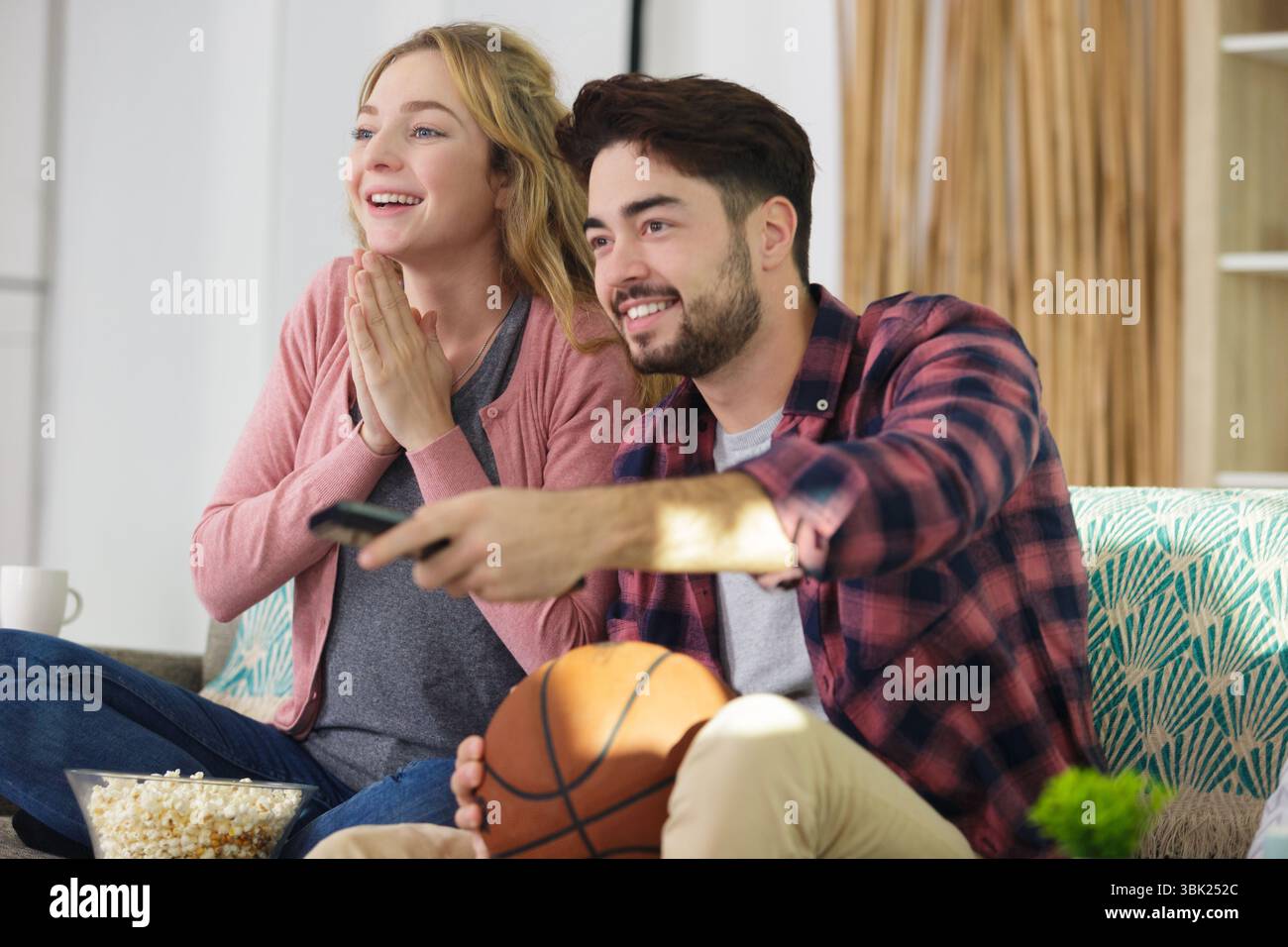 emotional couple cheering during basketball game at home Stock Photo ...