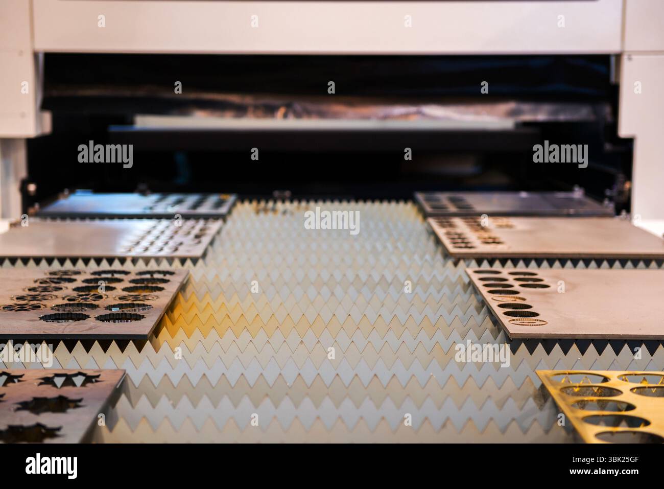 Laser cutter cutting metal plates in a factory Stock Photo - Alamy
