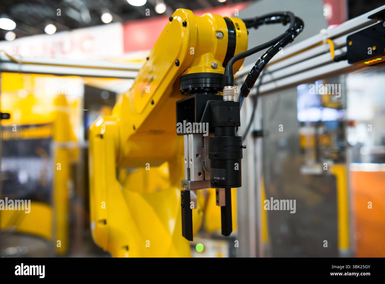 Robot arm in a factory working for the humans Stock Photo - Alamy