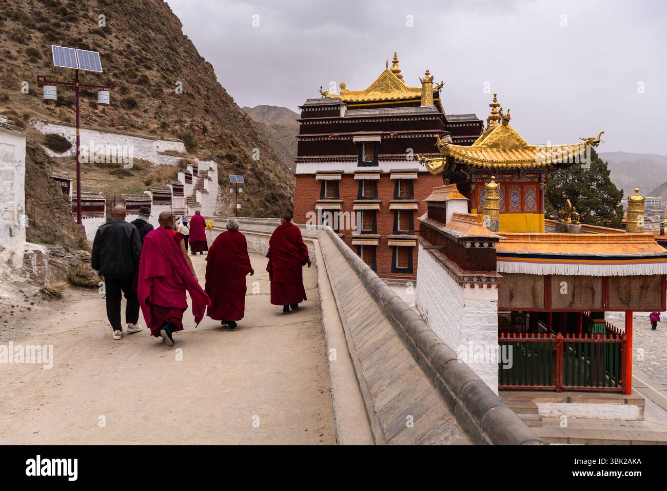 Xiahe, China - May 07 2025: Buddhist monks walks around the Tibetan Buddhism Labrang Monastery ...