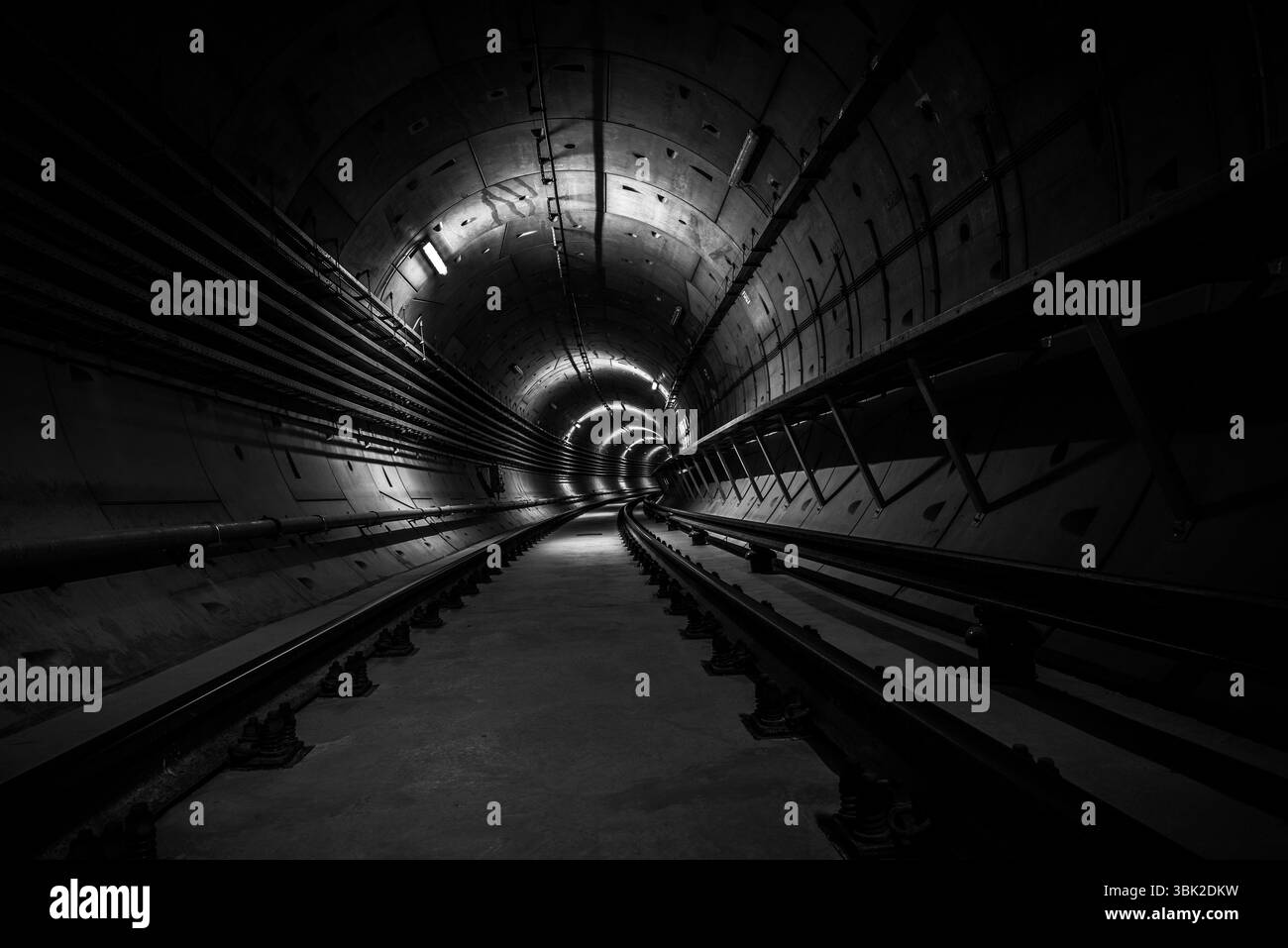 Underground tunnel for the subway leading deep down Stock Photo - Alamy
