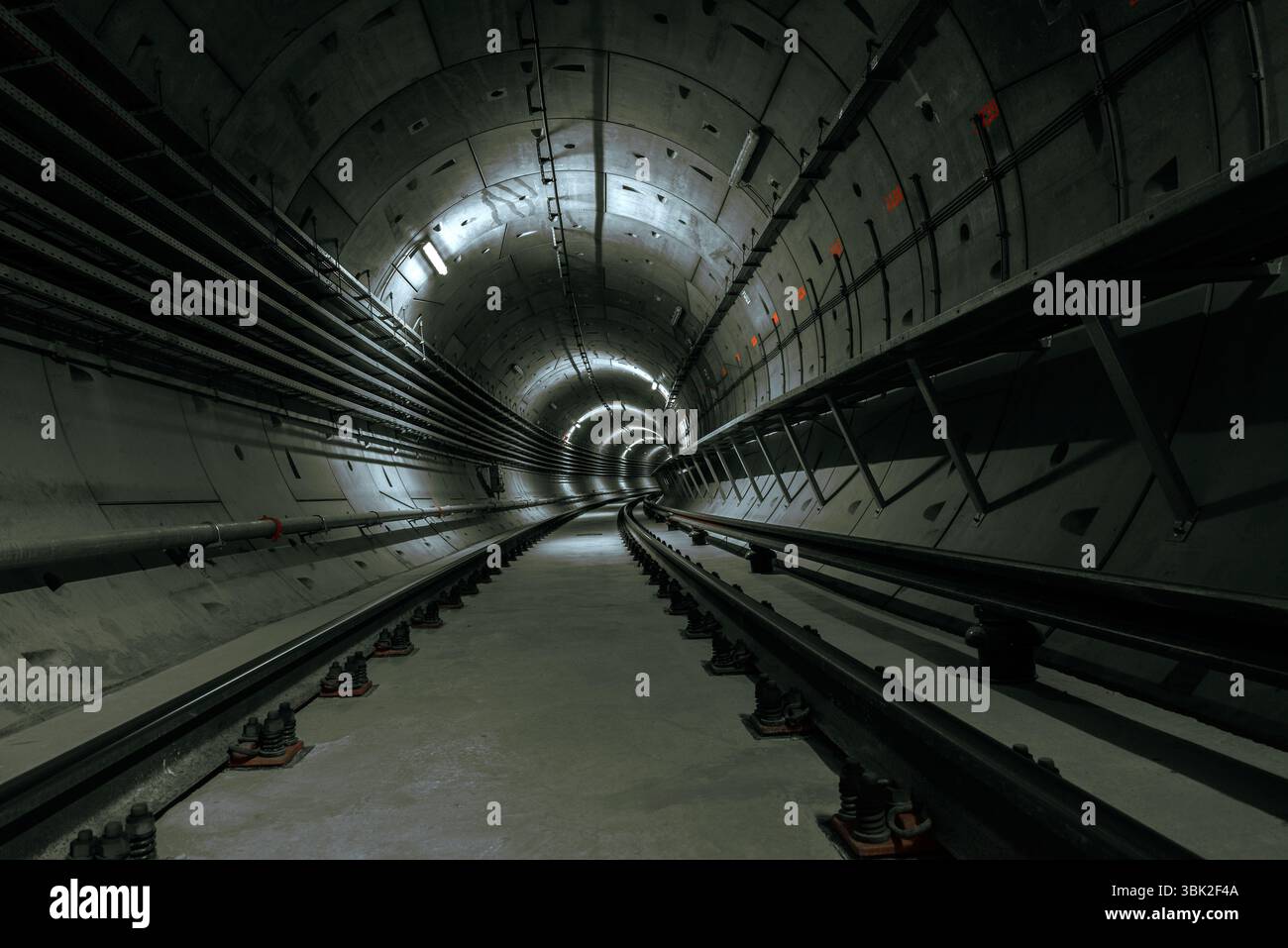 Underground tunnel for the subway leading deep down Stock Photo - Alamy