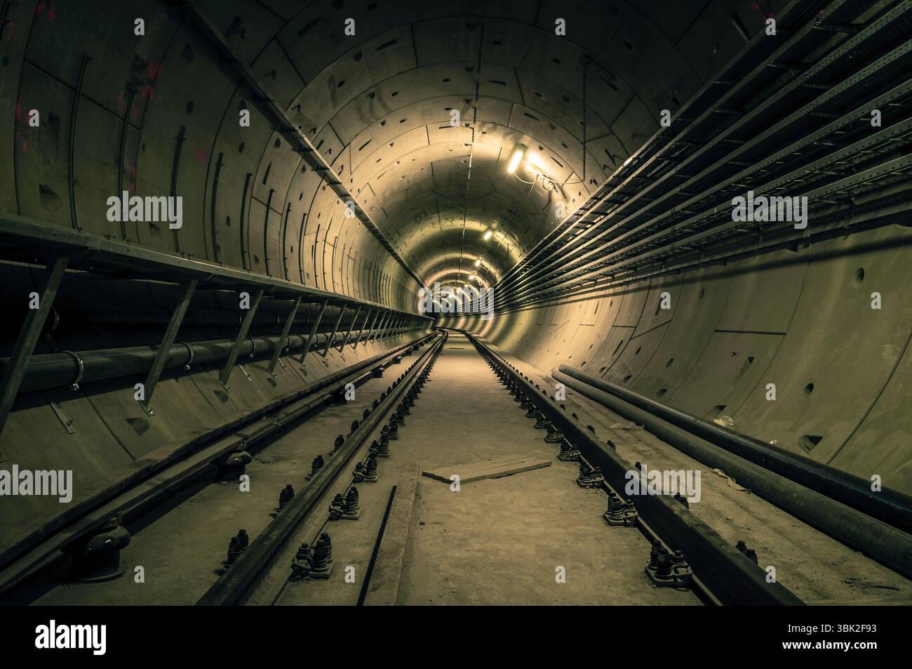 Underground facility with a big tunnel leading deep down Stock Photo ...