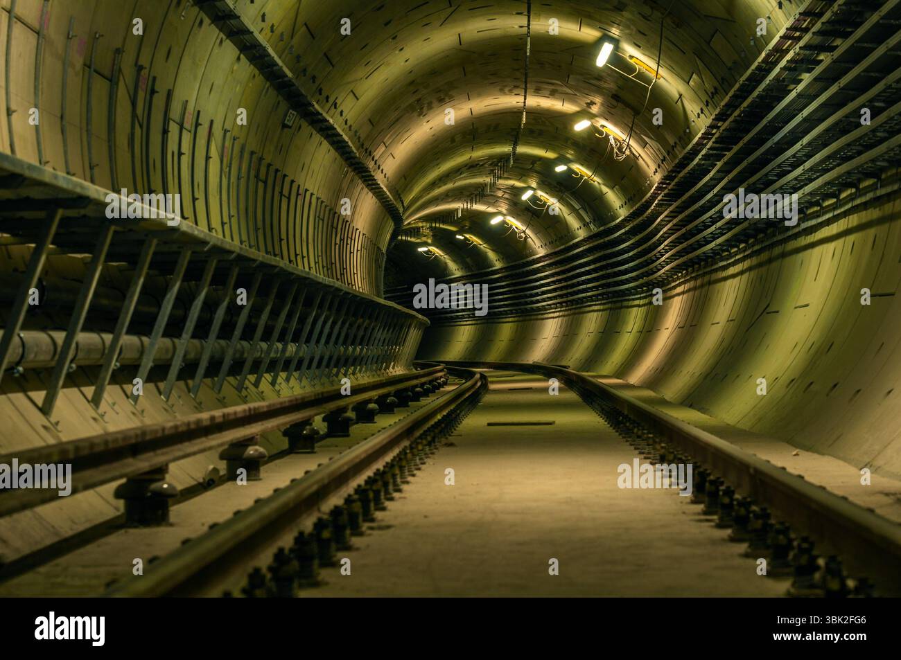 Underground facility with a big tunnel leading deep down Stock Photo ...