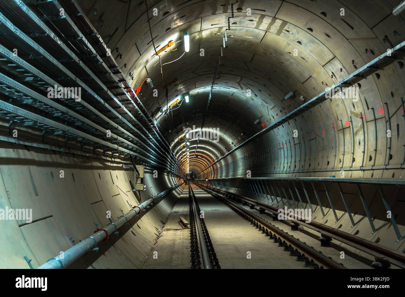 Underground facility with a big tunnel leading deep down Stock Photo ...