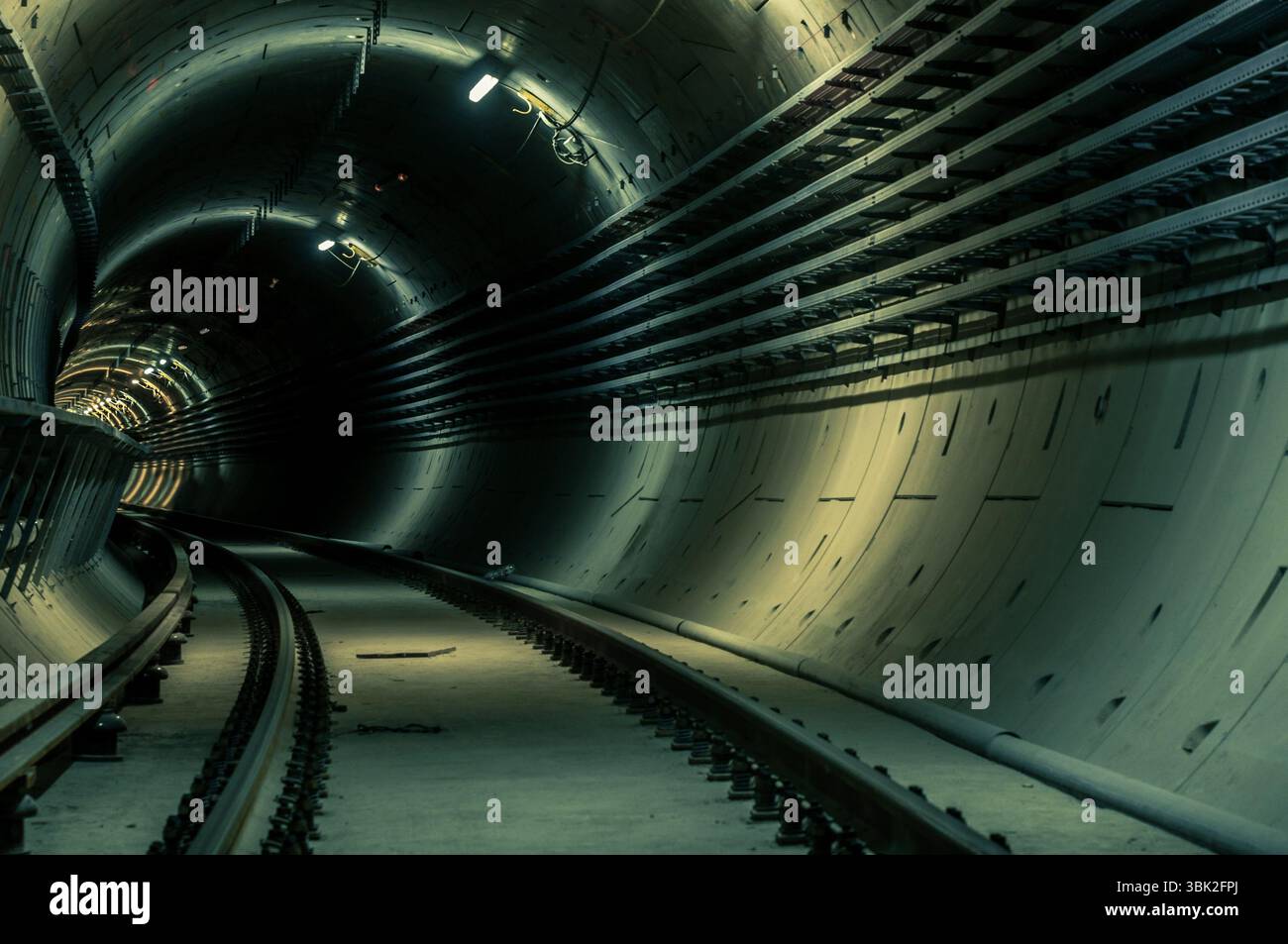 Underground facility with a big tunnel leading deep down Stock Photo ...