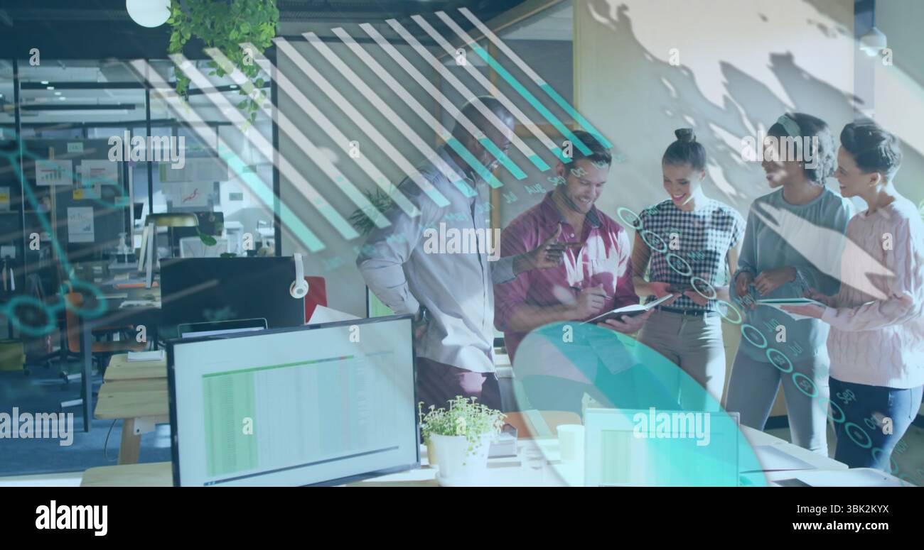 Collaborating team discussing strategy around desk in open-plan office ...