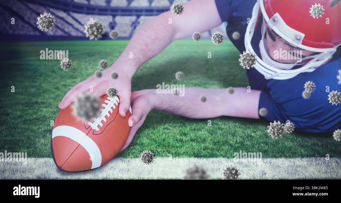 Diving football player in red helmet, jersey placing ball on stadium ...