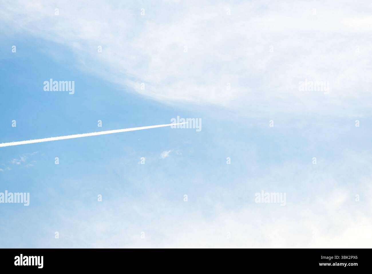 Airplane moving across blue sky with vapor trail hi-res stock ...