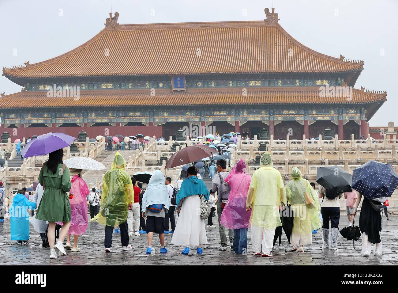 Tourists visit the Palace Museum in the rain in Beijing, China, 14 June ...
