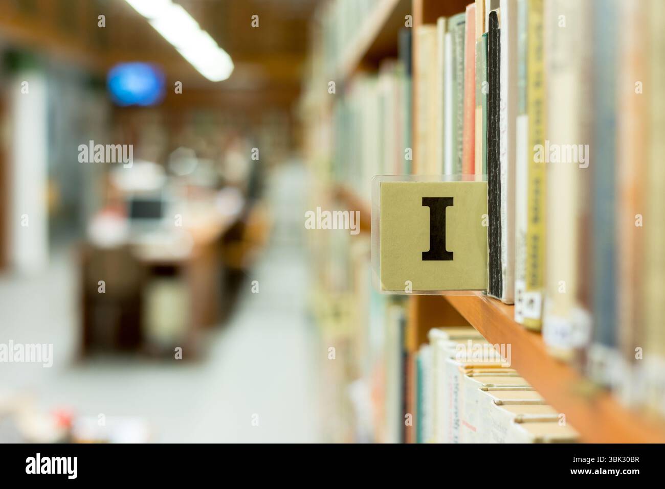 Library bookshelf extreme closeup with letter sign Stock Photo - Alamy
